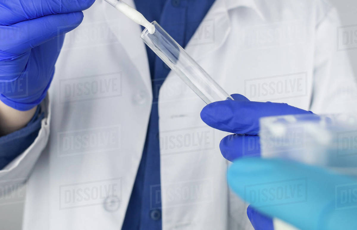 Medical laboratory assistant checks a test tube with sperm. Spermogram ...