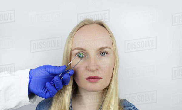 Conceptual shot of an eye crystalline lens replacement. Ophthalmic ...