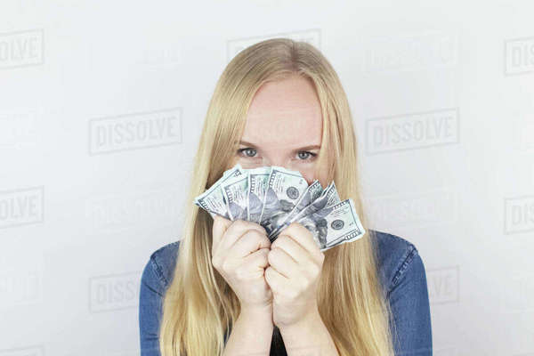 Close-up of a girl sniffing money. Madness and greed from currency. The ...