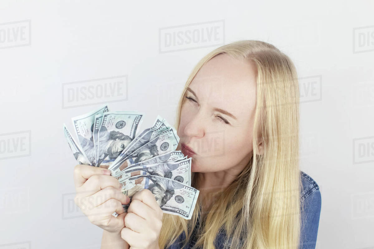 Close-up of a girl sniffing money. Madness and greed from currency. The ...
