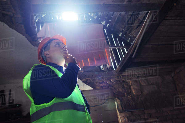 Building inspector. Man in a hard hat and a yellow reflective vest ...