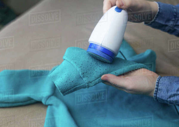 Machine for removing pellets. The girl uses a special device to remove ...