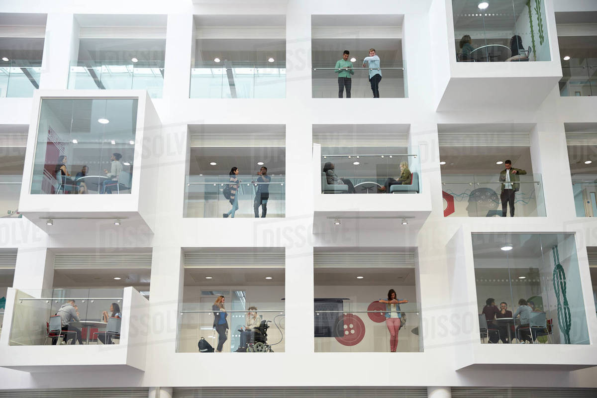 Students in study rooms, visible from the university lobby - Stock ...