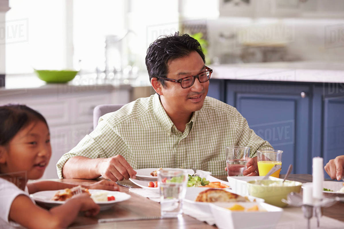 Family Eating Meal At Home Together - Royalty-free Stock Photo | Dissolve
