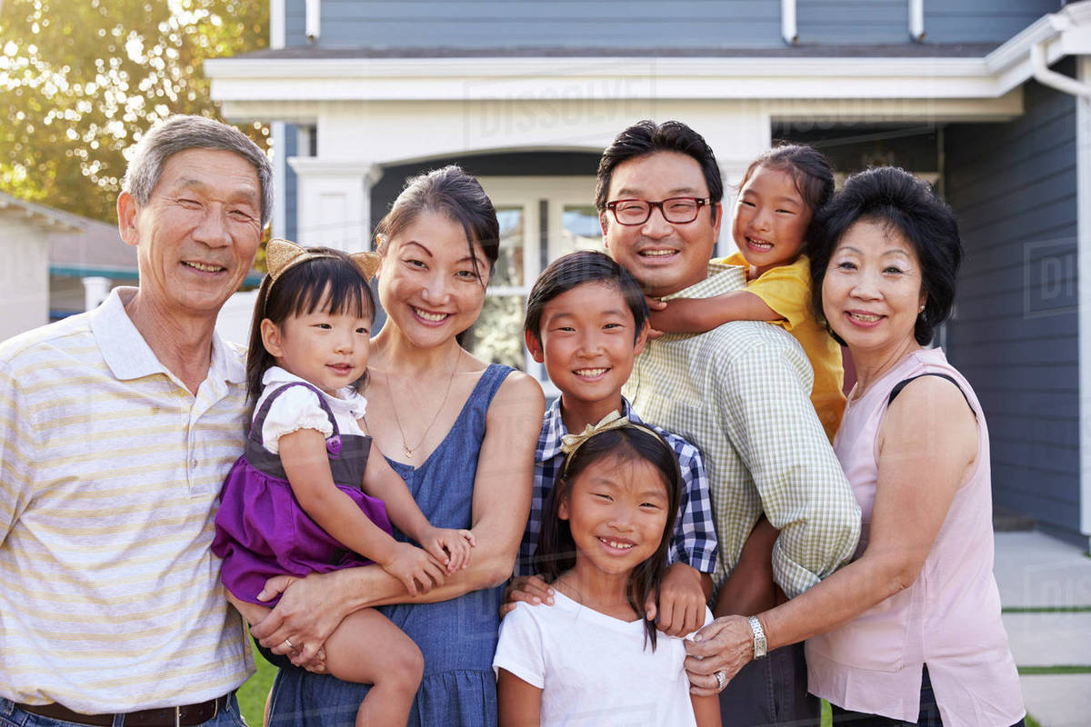 Portrait Of Family With Grandparents Standing Outside House - Royalty ...