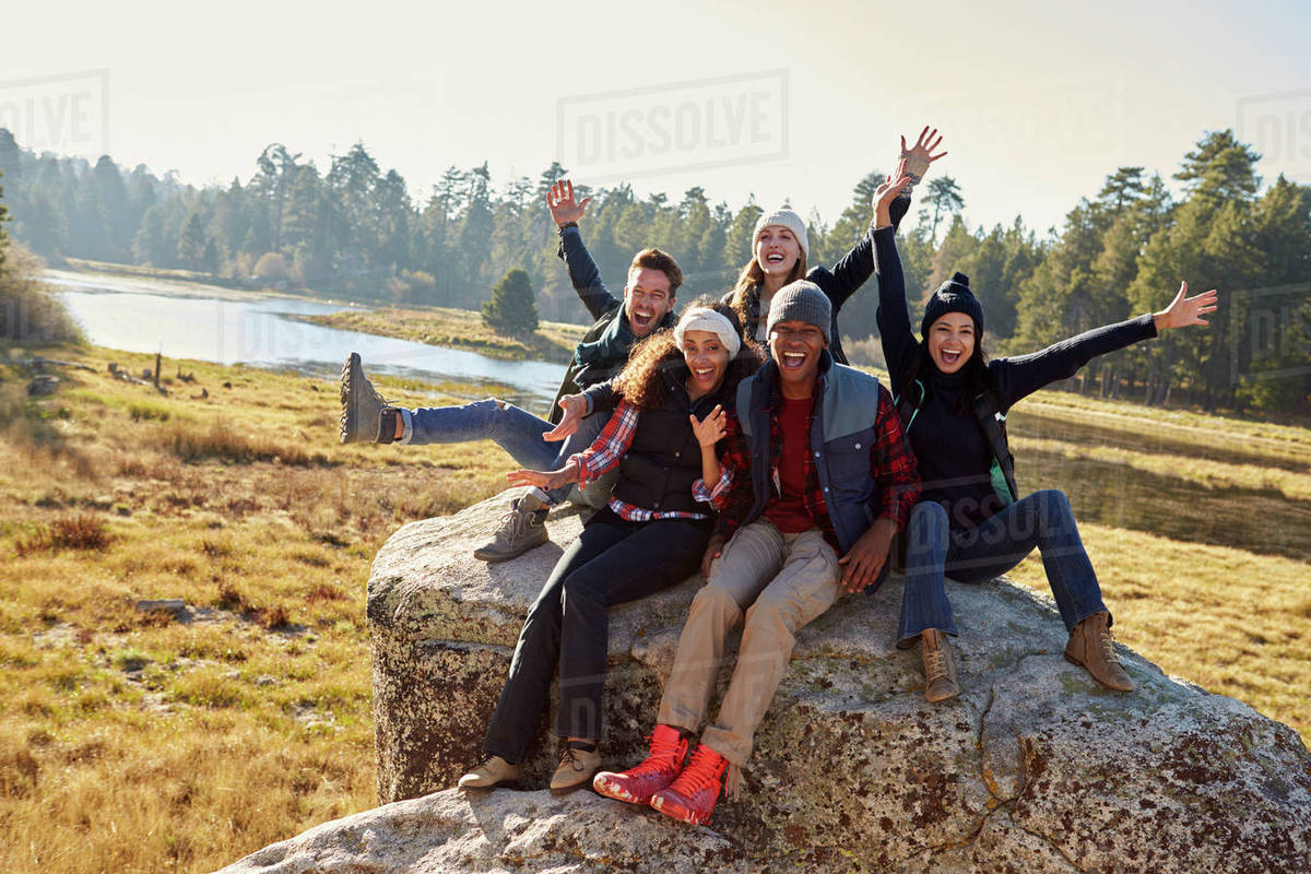 Portrait of five friends sitting on a rock in countryside - Royalty ...
