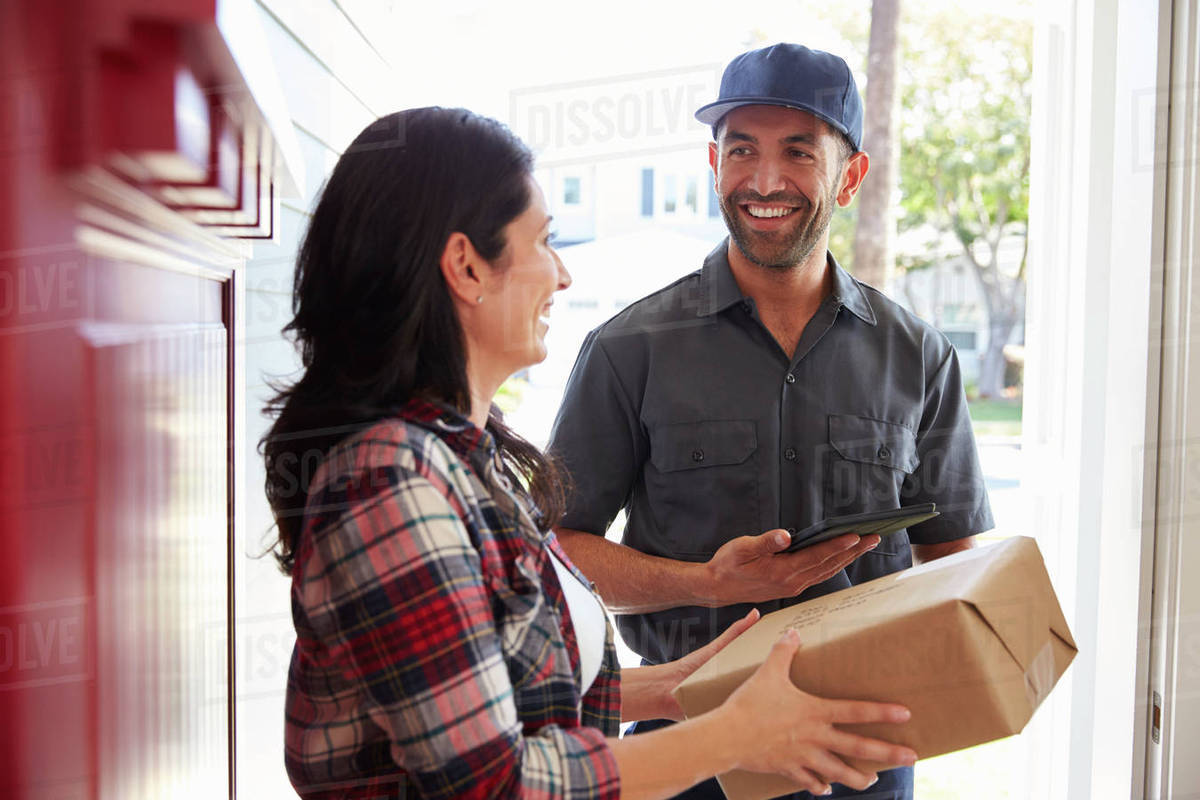 Woman Receiving Package From Courier At Home - Royalty-free Stock Photo ...