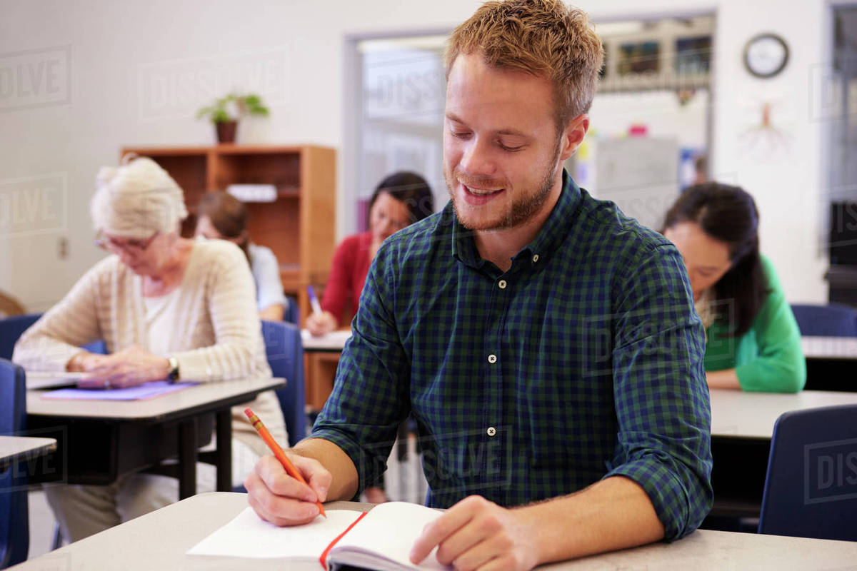 Young man studying at an adult education class - Royalty-free Stock ...