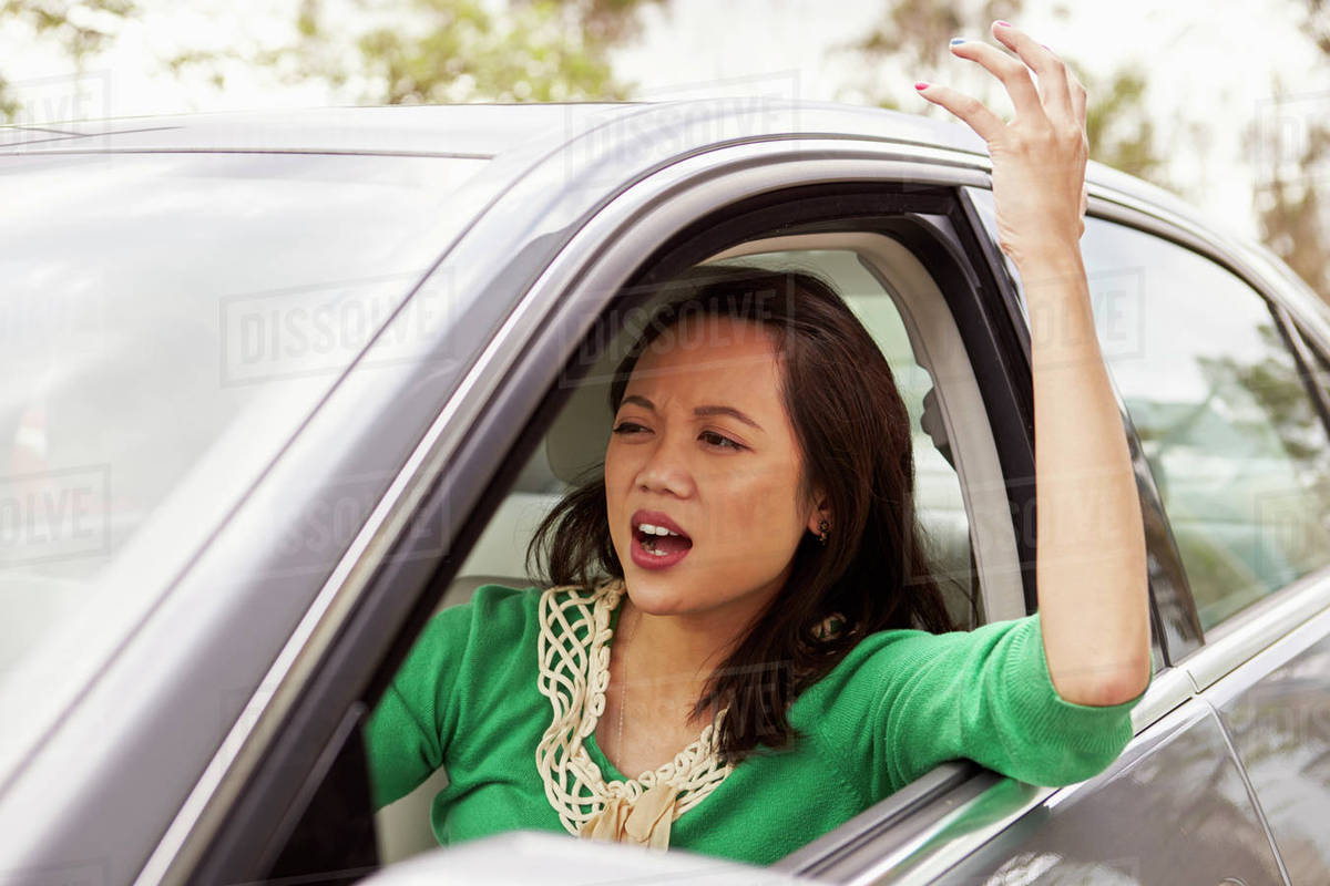 Frustrated female Asian driver in a car - Royalty-free Stock Photo ...