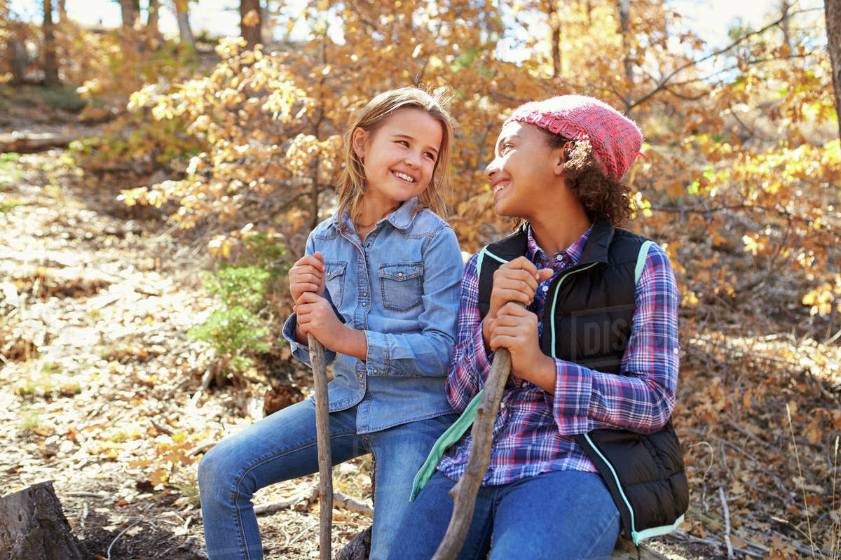 Two Girls Playing In Autumn Woods Together - Royalty-free Stock Photo ...