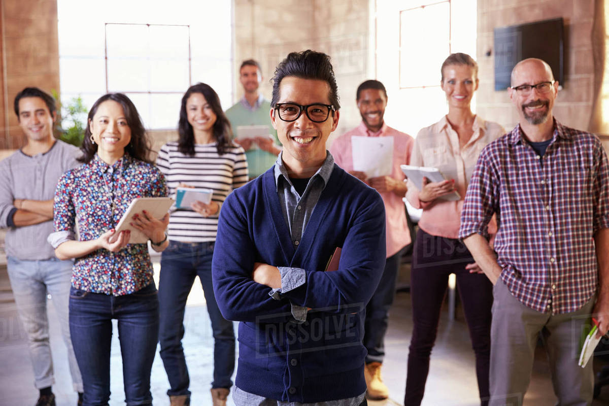 Portrait of staff standing in modern design office - Stock Photo - Dissolve