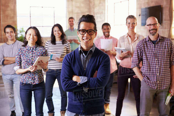 Portrait of staff standing in modern design office - Stock Photo - Dissolve