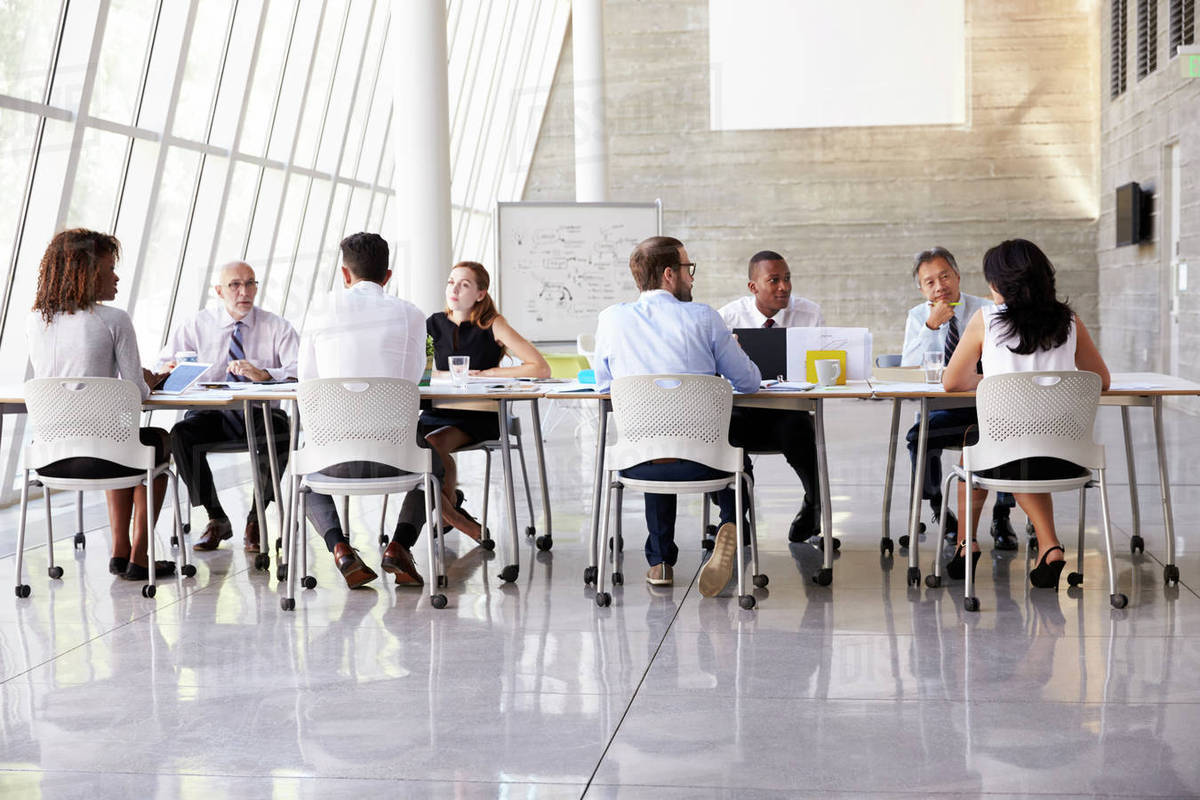 Group business meeting around table in modern office - Stock Photo ...