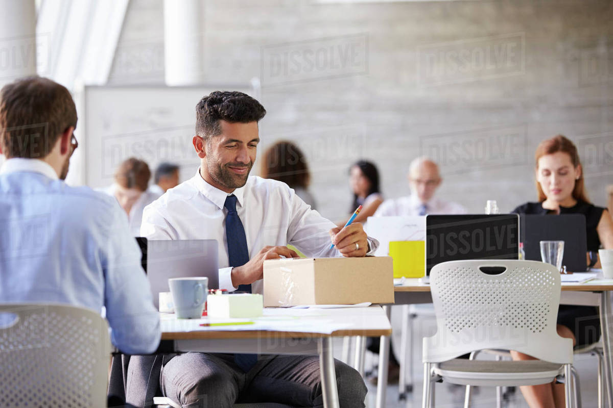 Businessman in office addressing package for shipping - Royalty-free ...