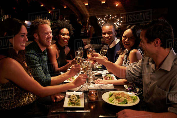 Group of friends enjoying meal in restaurant - Royalty-free Stock Photo ...
