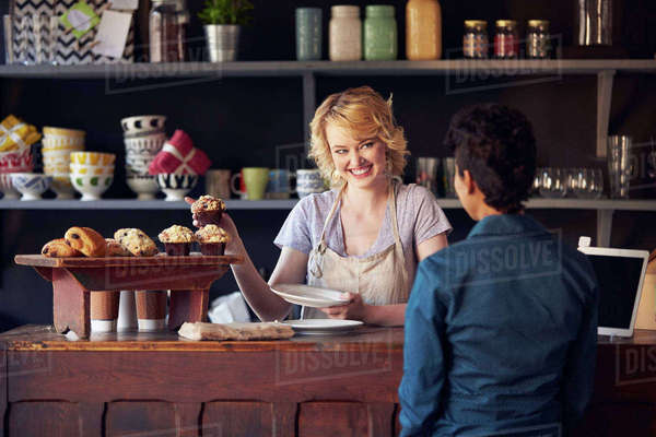Staff Serving Customer In Busy Coffee Shop - Stock Photo - Dissolve