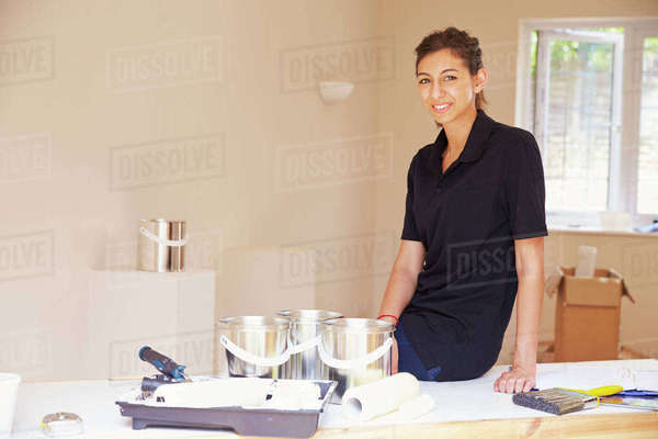 Portrait of smiling female decorator - Royalty-free Stock Photo | Dissolve