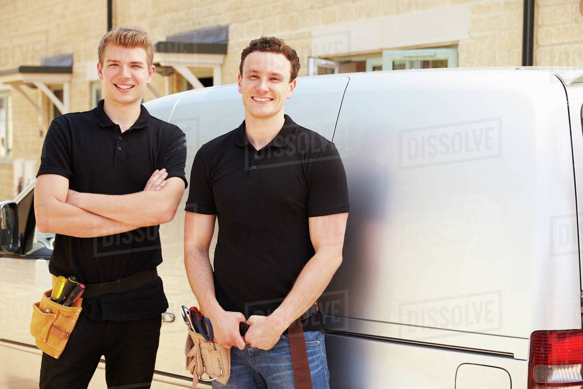 Portrait of two young tradesmen by their van - Royalty-free Stock Photo ...