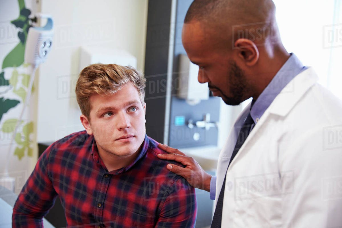 Male patient being reassured by doctor in hospital room - Stock Photo ...