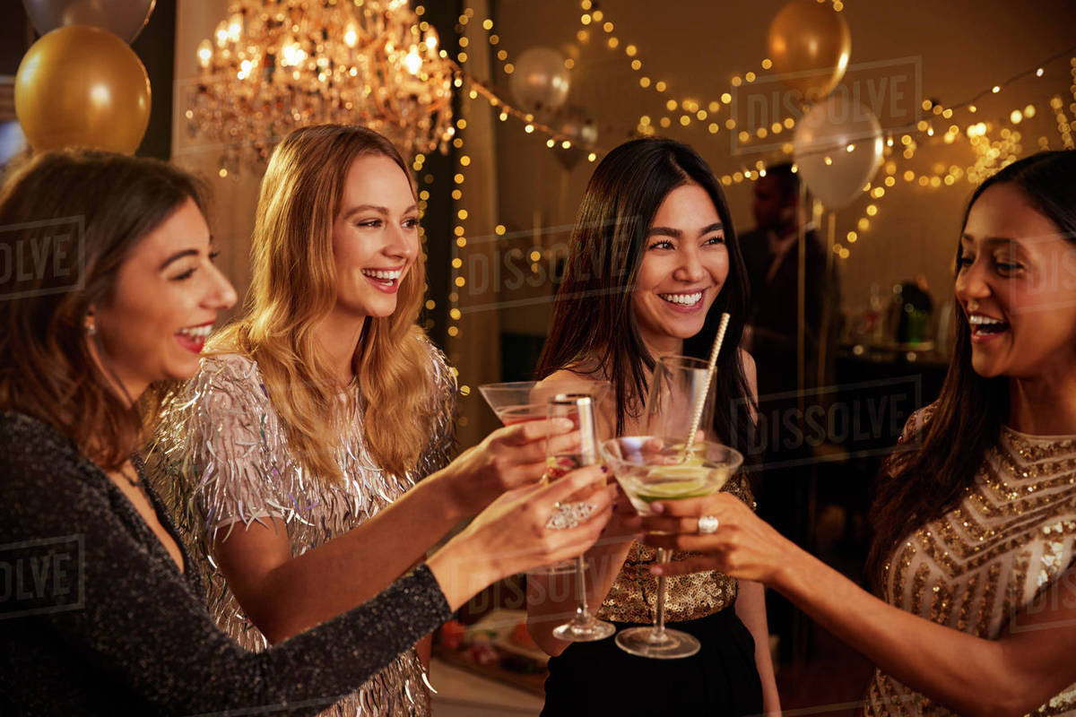Female friends make toast as they celebrate at party - Royalty-free ...