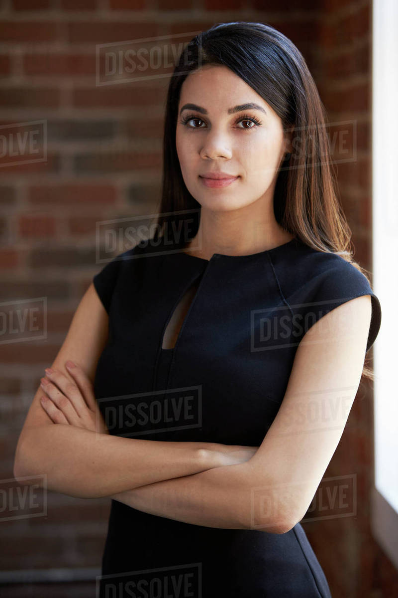 Head and shoulders portrait of young businesswoman in office - Royalty ...