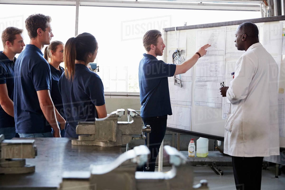Engineering apprentice presenting to group at whiteboard - Stock Photo ...