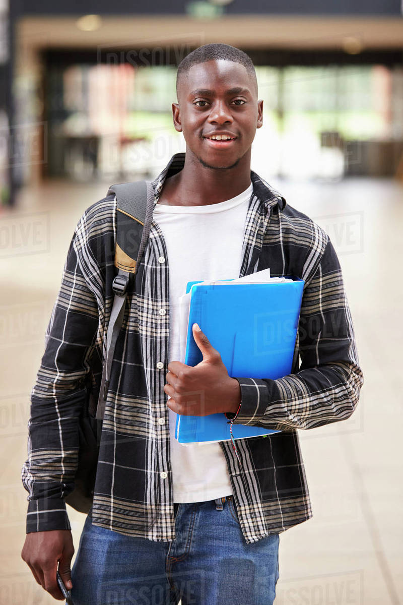 Portrait Of Male Student Standing In College Building - Royalty-free ...