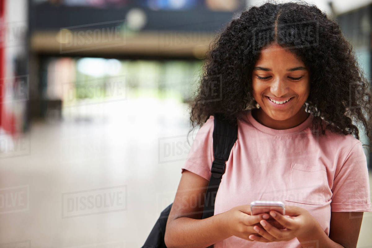 Female College Student Reading Text Message On Mobile Phone - Stock ...