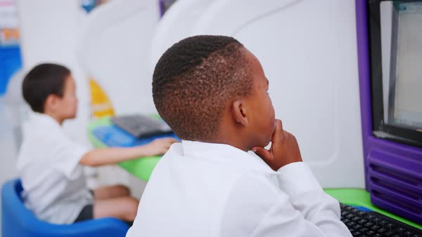 Young black boy using computer at a science centre - 4K Royalty-free ...