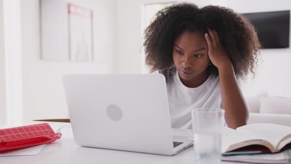 Young teenage black girl using laptop computer at home - Stock Video ...