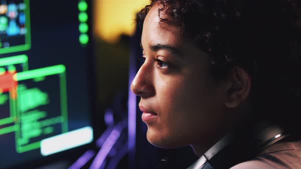 Female Teenage Hacker Sitting In Front Of Computer Screens Bypassing ...