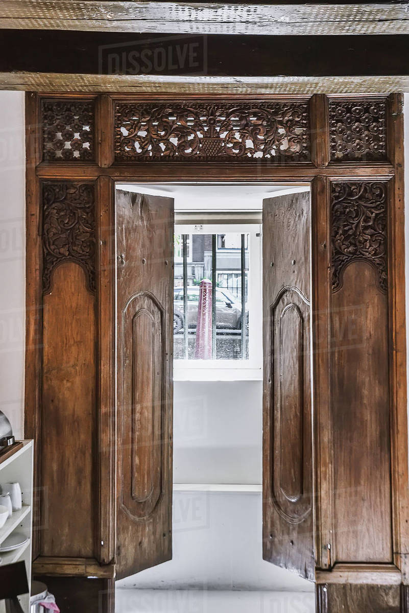 Ornamental element of transom window above carved aged doorway in old ...