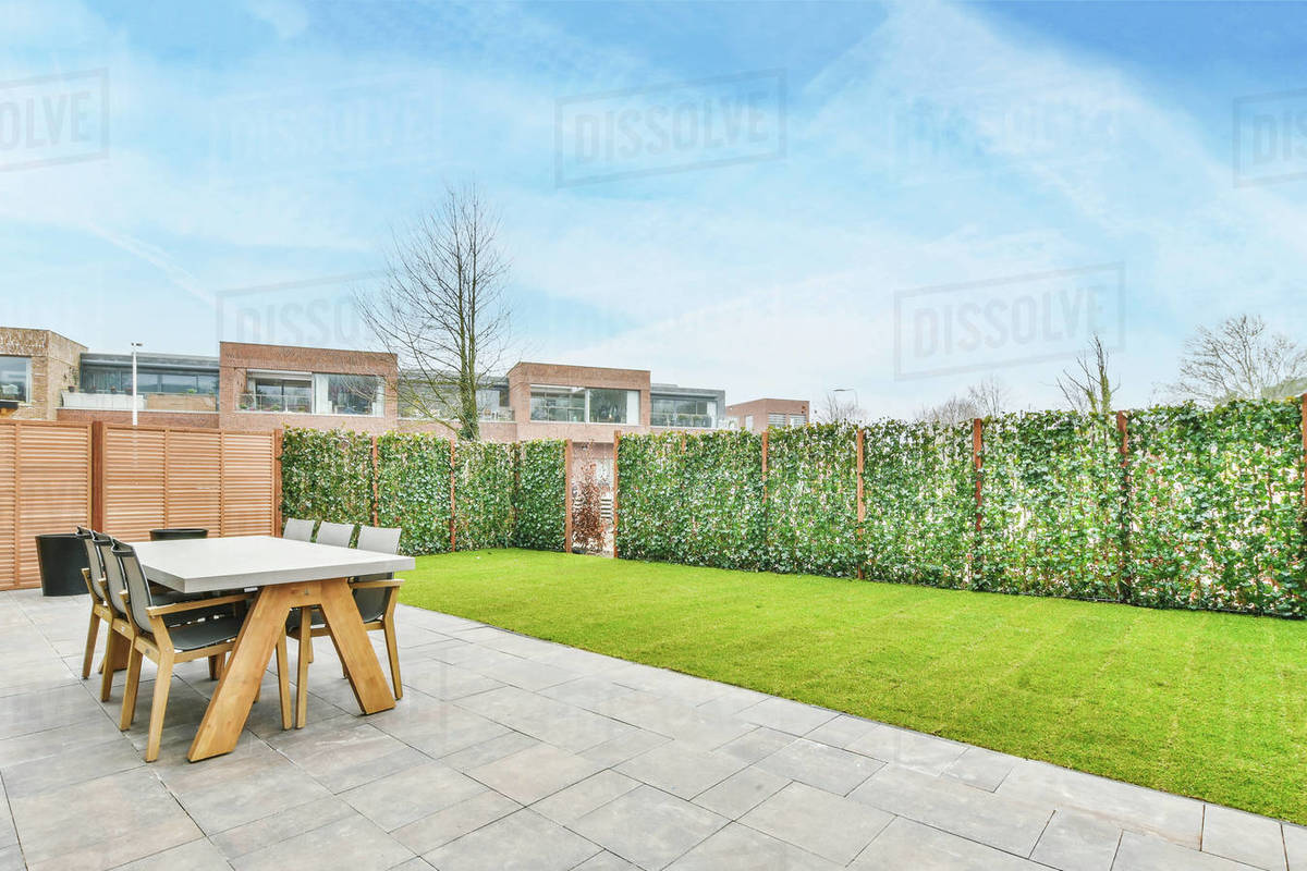 Beautiful backyard terrace full of furniture and decorative plants ...