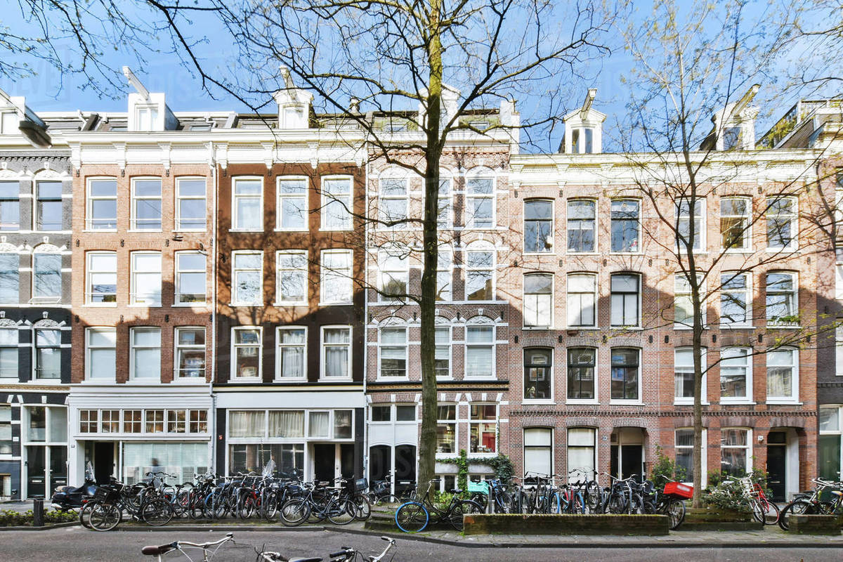 Exterior of typical stone multistory residential building with arched ...
