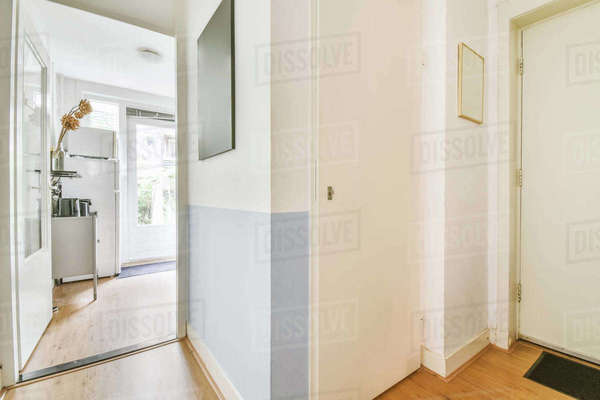 Delicate corner corridor with paintings hanging on the wall - Royalty ...