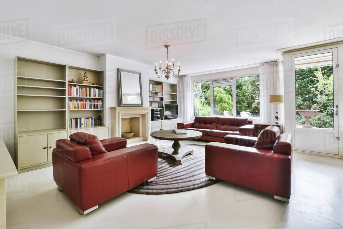 Stylish living room with big red sofa - Royalty-free Stock Photo | Dissolve