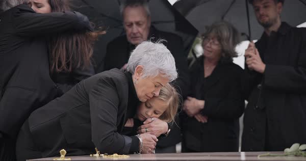 Funeral, crying family and child hug grandmother for support, mourning ...