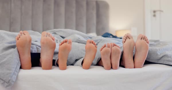 Sleeping, feet and family in a bed relax, dreaming or bond in vacation ...