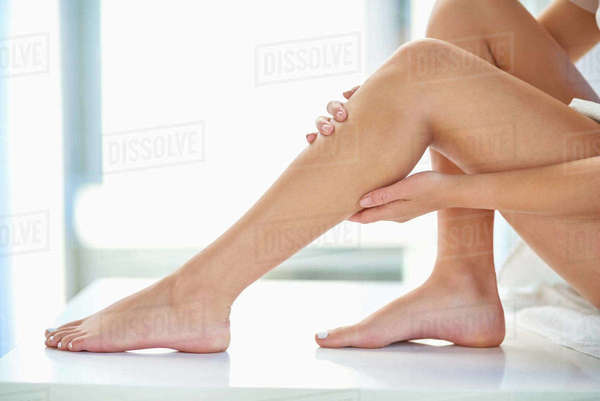 Skincare, soft and legs of a woman after waxing, grooming and cleaning ...