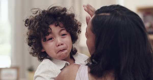 Sad, child and mother wipe tears, care and love of family bonding ...
