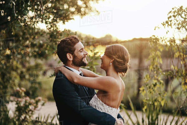 Happy married couple, hug and smile for wedding, marriage or commitment ...