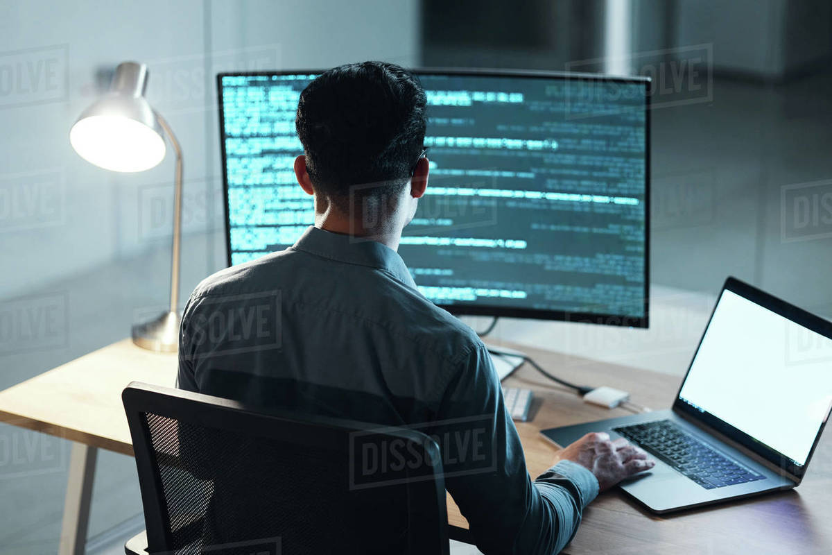 Office, programming and man with technology, code and typing with data ...