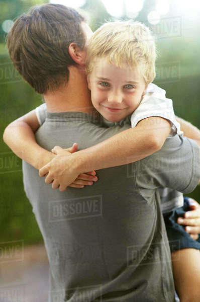 Portrait of father hugging child in backyard, cute bonding together in ...