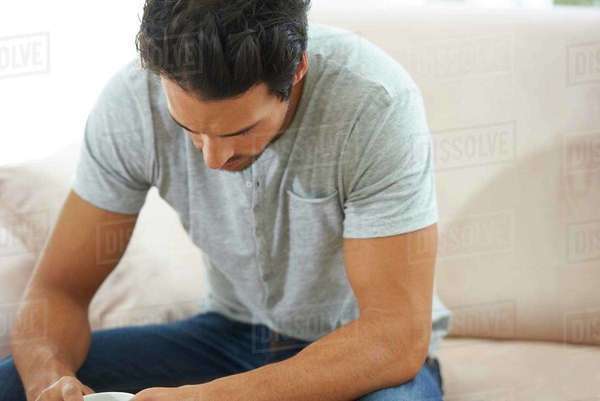 Thinking, depression and sad man on a sofa with stress, anxiety or ...