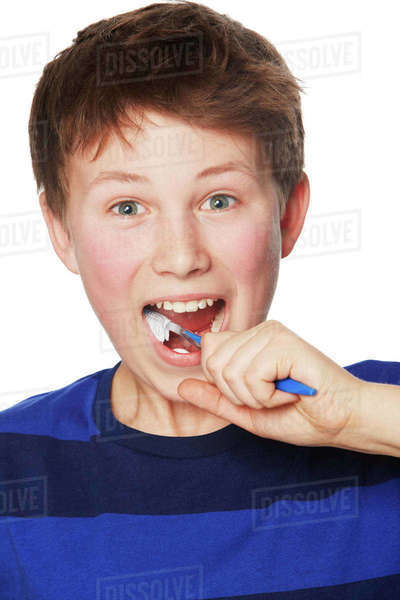 Face, smile and child brushing teeth in studio isolated on a white ...