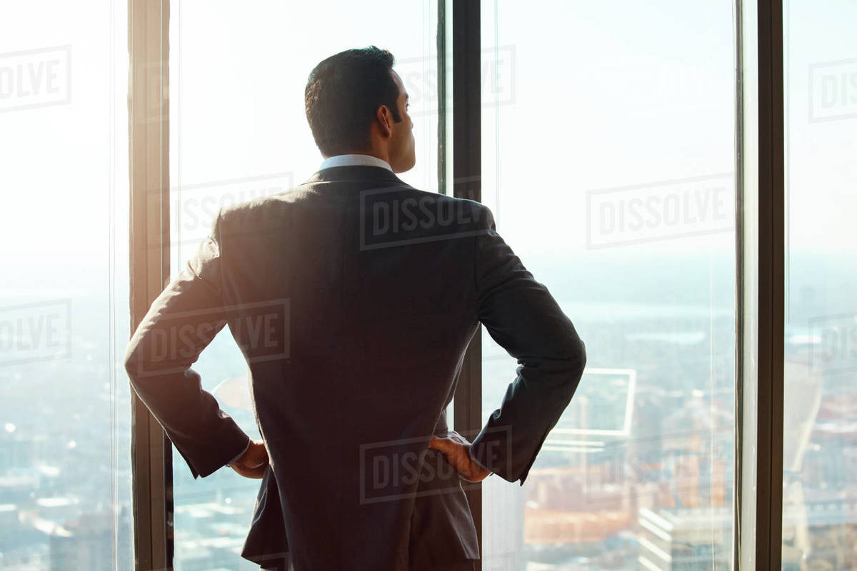 Business man, building and window for thinking of ideas, future plan or ...