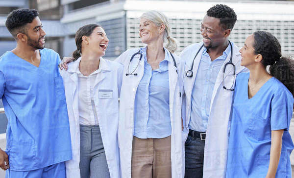 Doctor team, city and laugh with hug and happiness from healthcare and ...