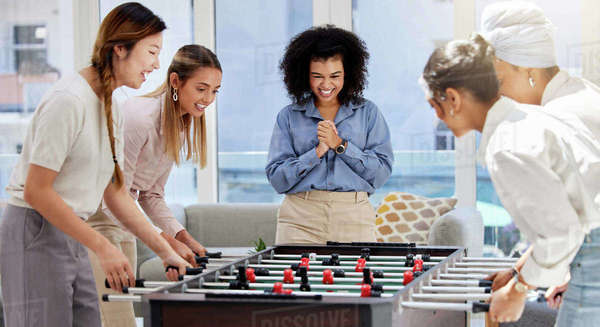 Team building, break and business women playing game in office lounge ...