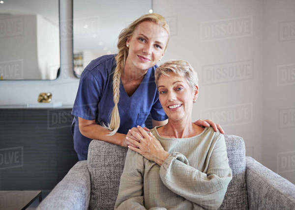 Portrait of elderly woman with a nurse, bonding during checkup at ...