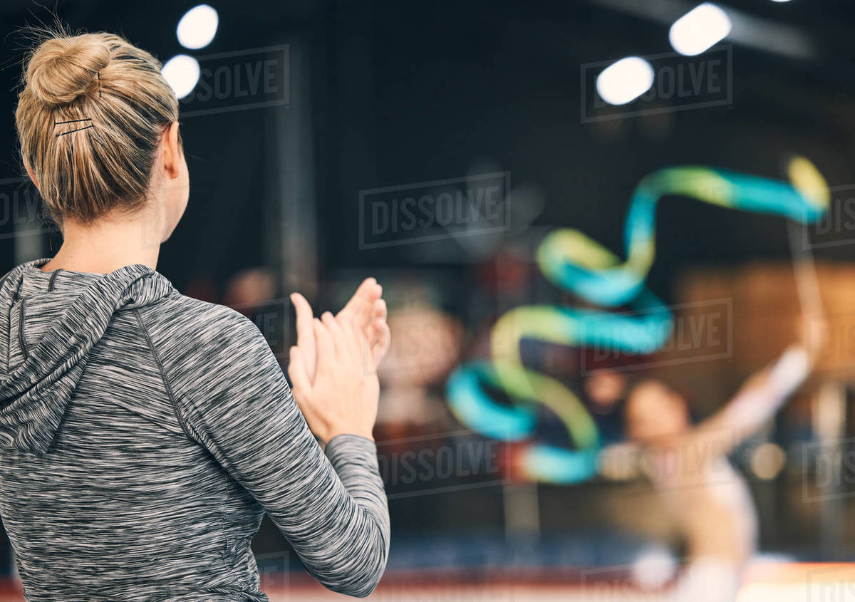 Coaching, gymnastics and clapping with woman in stadium for training ...